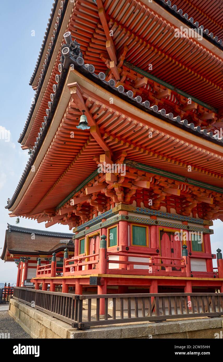 The close up view up of the vermilion three-storied pagoda on the hill ...