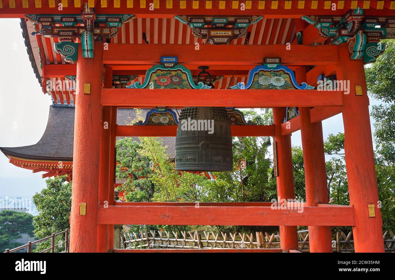 The close up view of the bright decorated vermilion bell tower (shoro ...