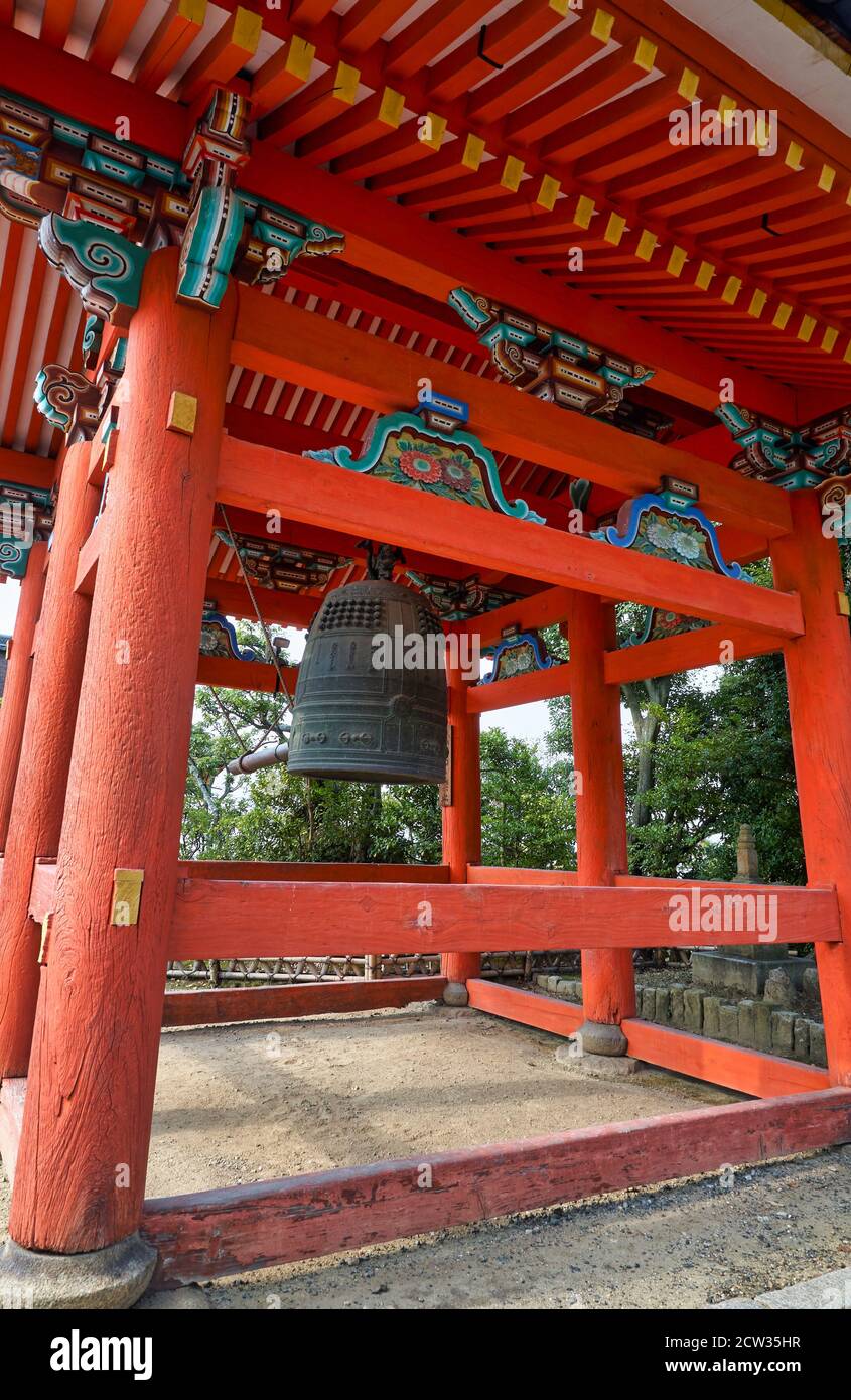 The close up view of the bright decorated vermilion bell tower (shoro ...