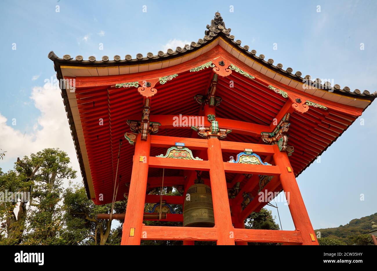 The close up view of the bright decorated vermilion bell tower (shoro ...