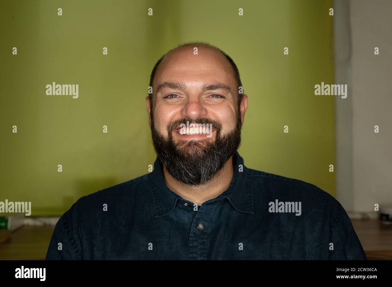 Man smiles friendly at the camera Stock Photo - Alamy