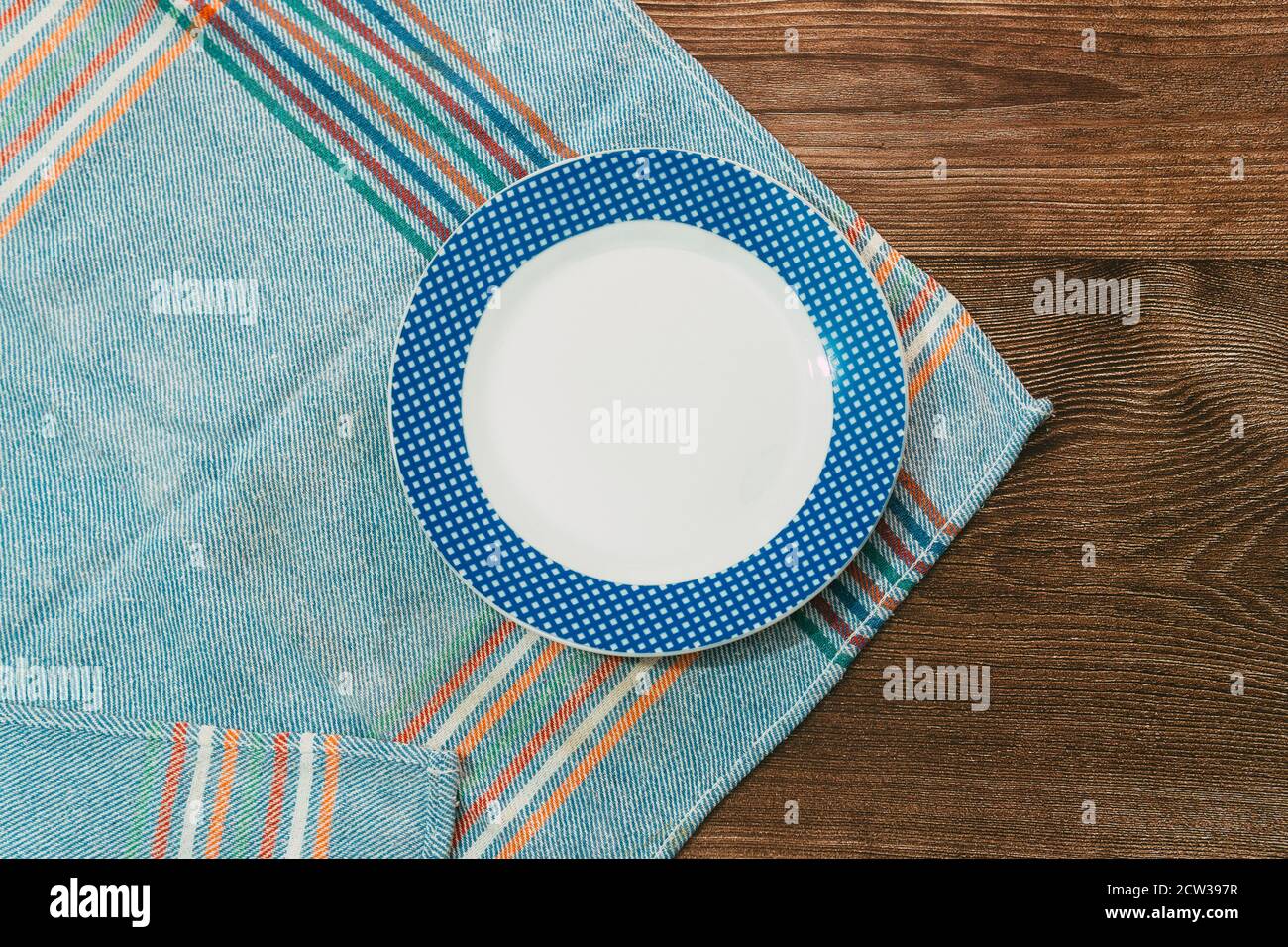 Top view of a plate with blue patterns placed on a table cloth on a ...