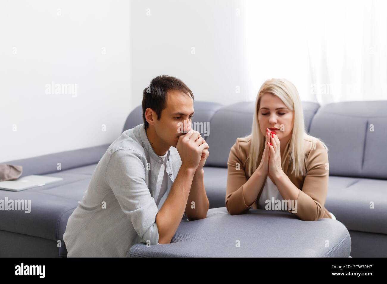 Young family praying at home Stock Photo - Alamy