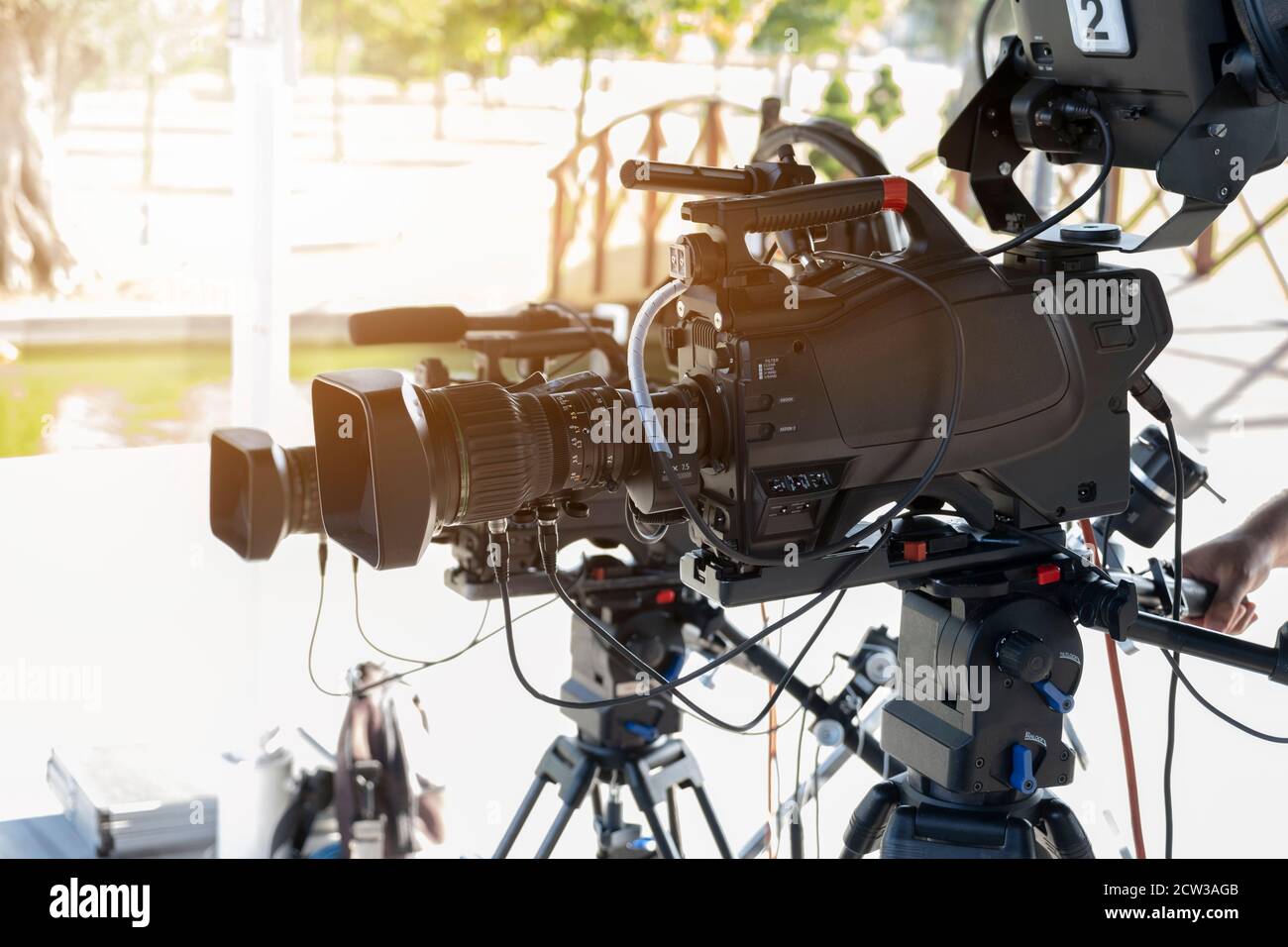 The cameraman is on duty and two camera lenses for broadcast are ...