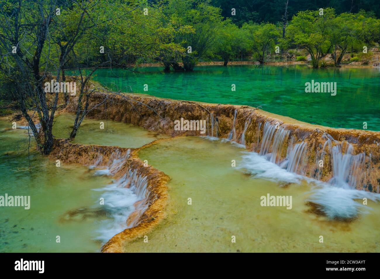 The small waterfalls and colorful pools in Huanglong Valley, Sichuan ...