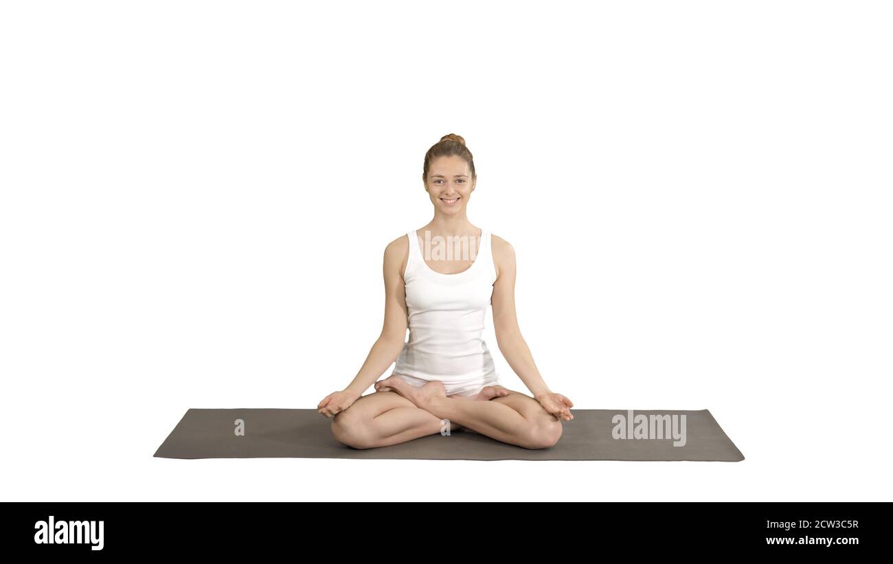 Relaxed woman in yoga position putting hands together and meditating on ...