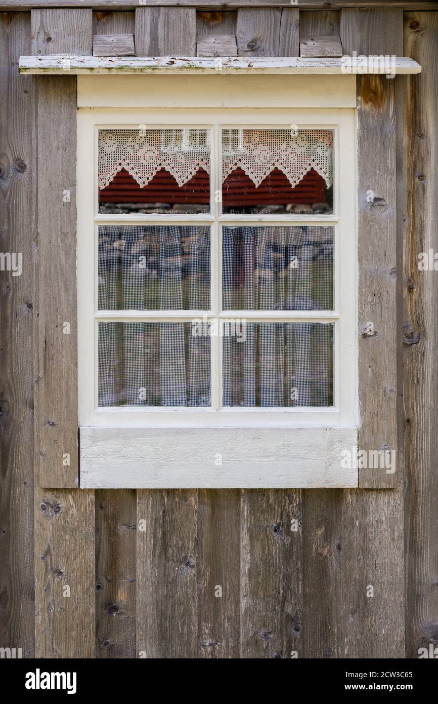 ROMEDALEN, NORWAY - 2014 JULY 21. White framed window on a old farm ...
