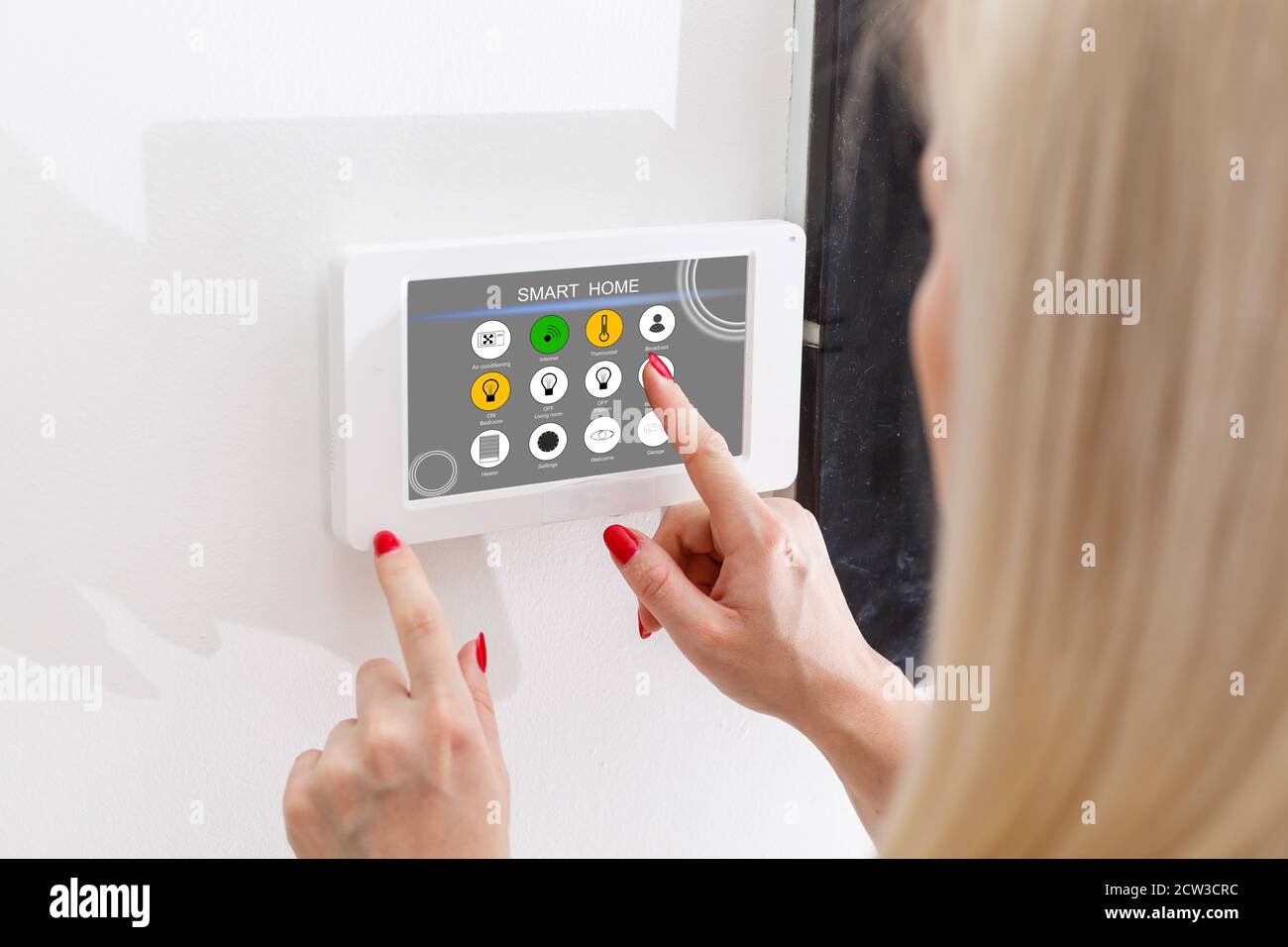 Woman dialing intercom, smart House Stock Photo - Alamy