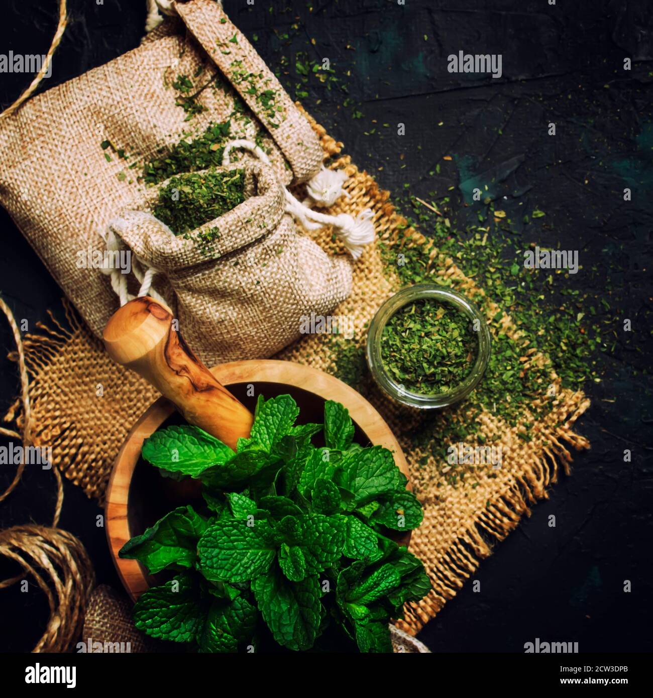 Dried peppermint in a glass jar and a bunch of fresh mint, medicine ...