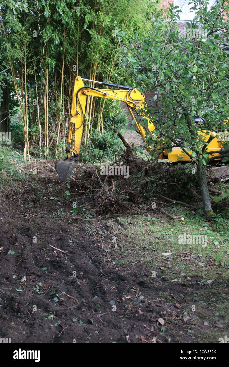 Yellow digger heavy motor machinery with digging arm moving earth, re ...