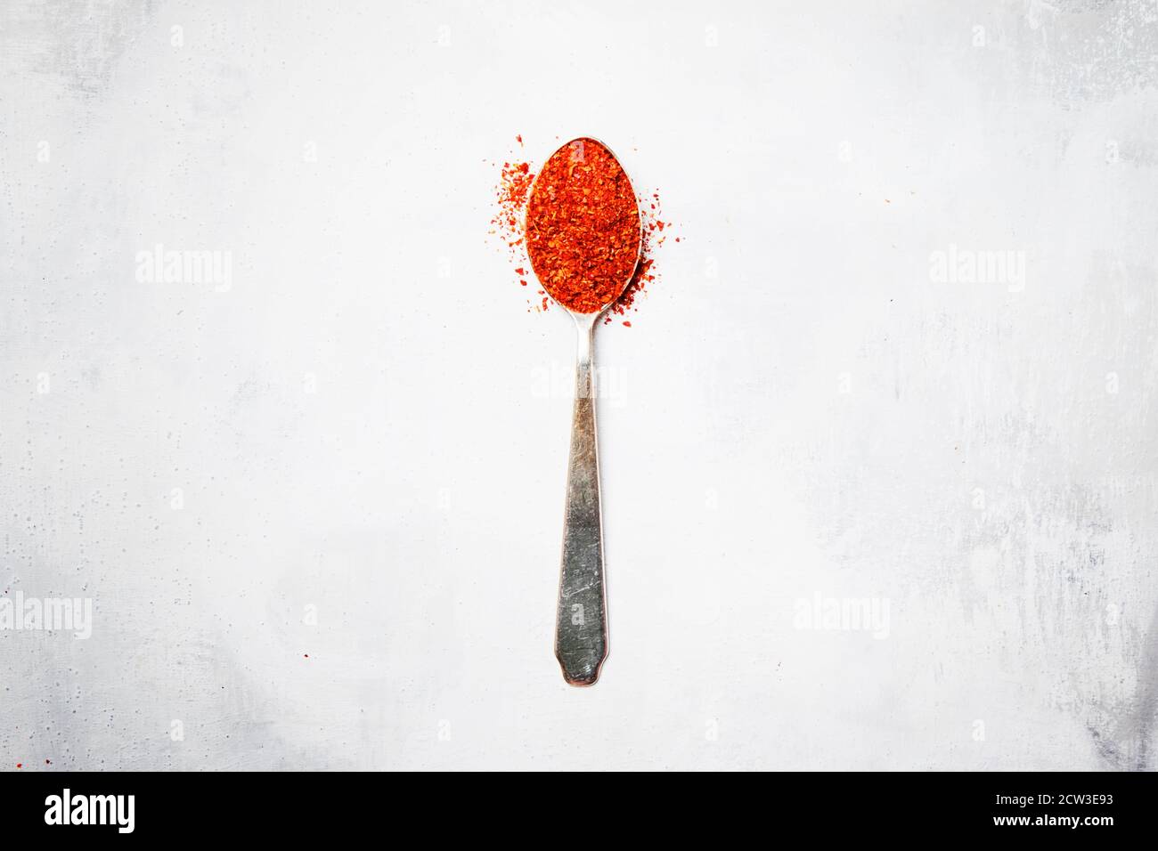 Ground red hot chili pepper in spoon, top view Stock Photo - Alamy
