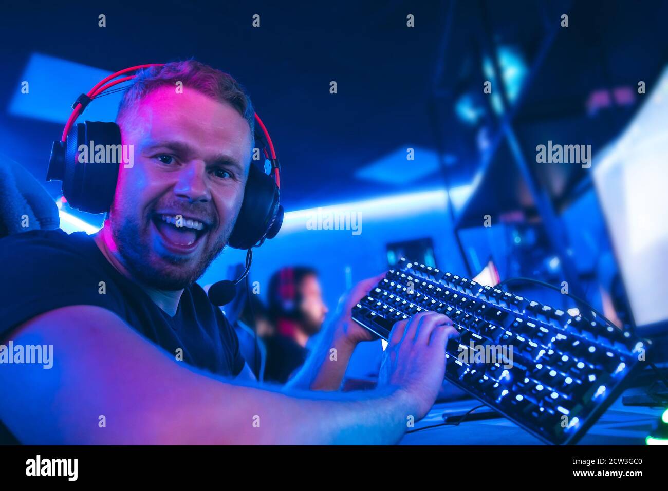 Young man gamer play online video games with headphones in internet ...