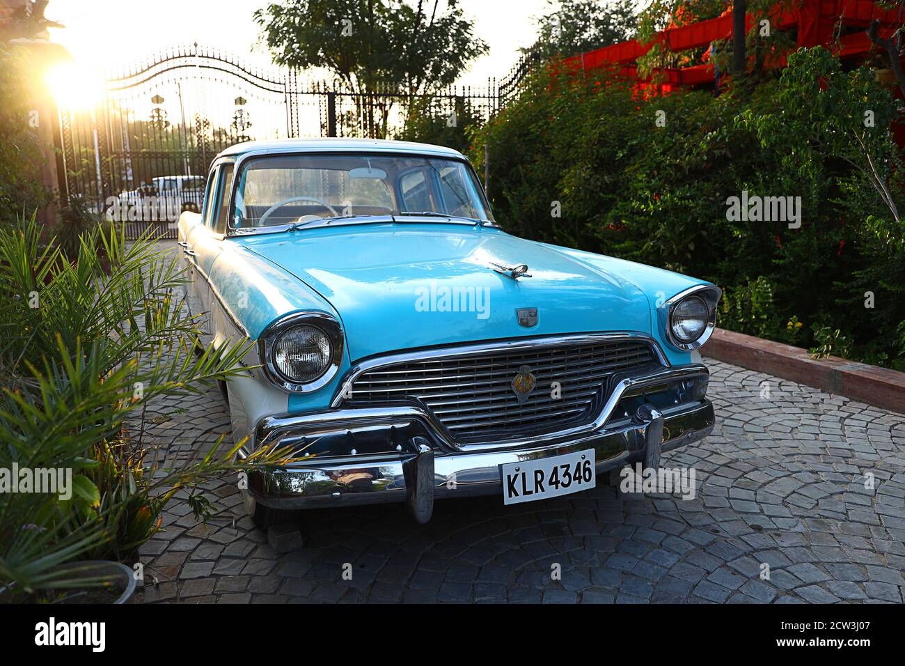 Portrait of an old retro blue commander vintage car parked at driveway ...