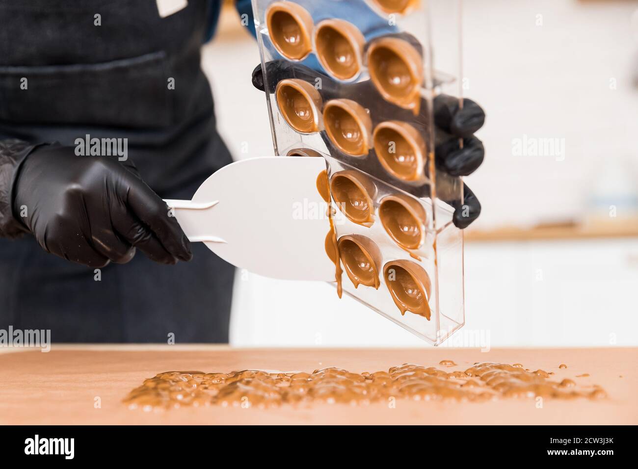 Chef or chocolatier making sweet chocolates home on background of ...