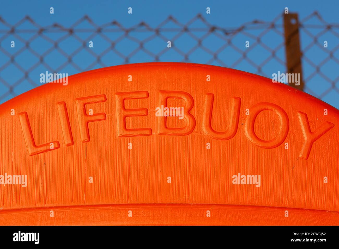The word lifebuoy on an orange container that hold a life ring Stock ...
