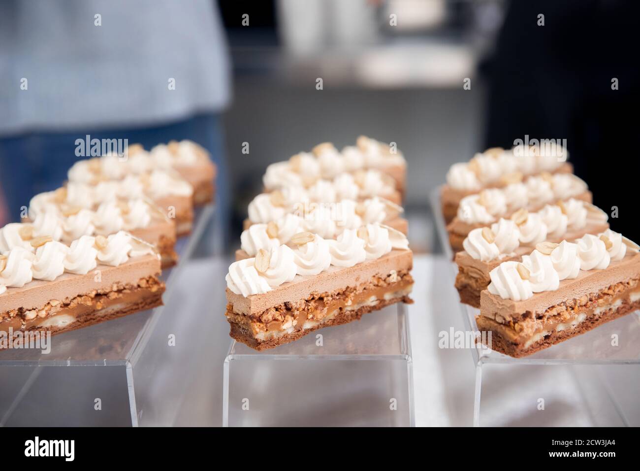 Close-ups of row cake buttercream brownies on display catering sweet ...