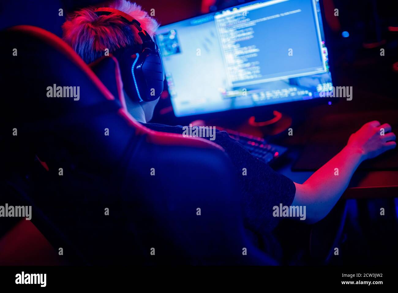 Professional gamer playing tournaments online video games computer with ...