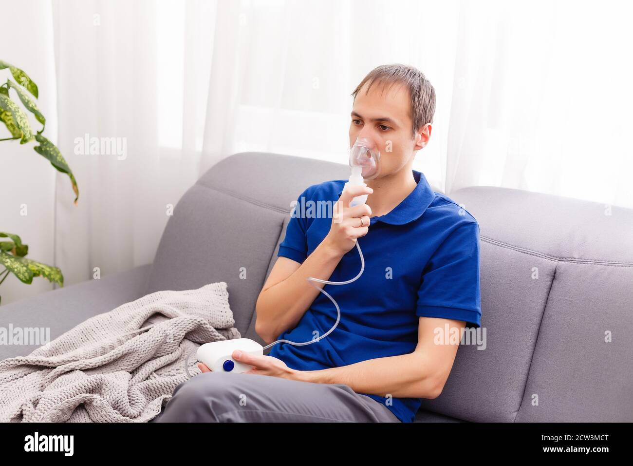Portrait Of Young Man Inhaling Through Inhaler Mask Stock Photo - Alamy