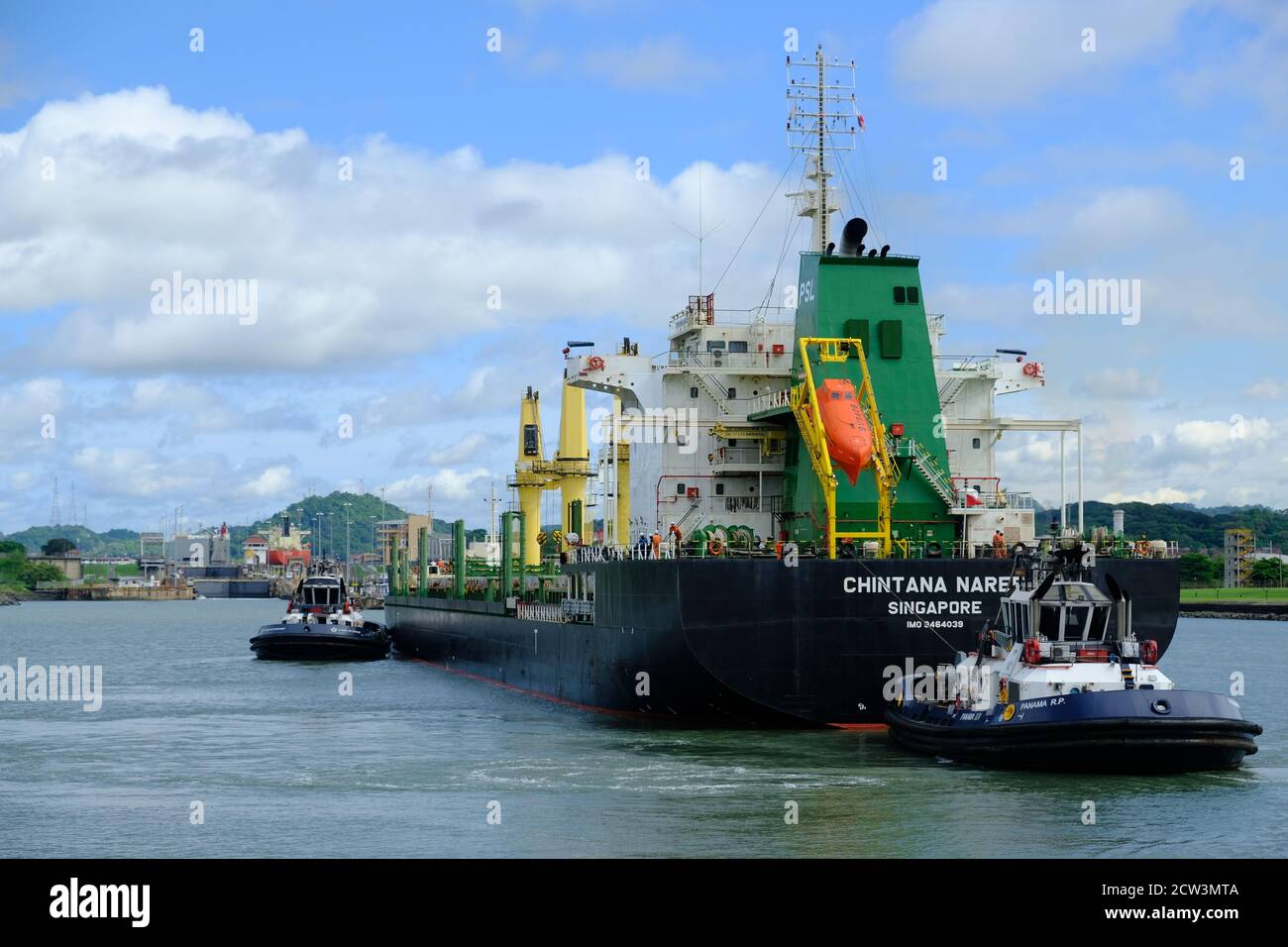 Panama Canal - Canal de Panama - Tugboats pulling a freighter Stock ...