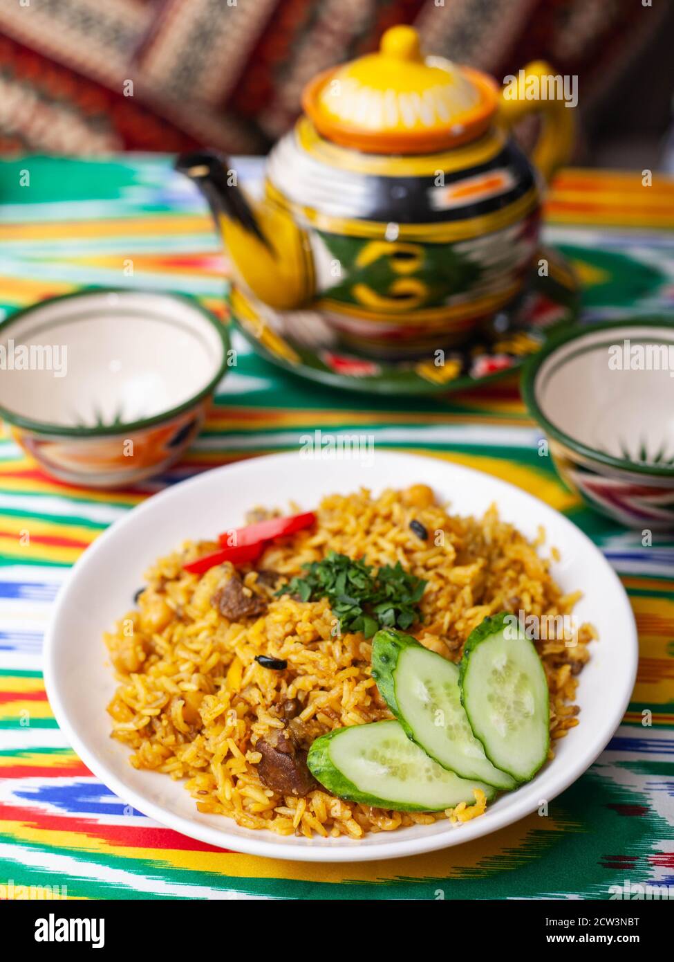 National Uzbek pilaf with meat on the table in the Uzbek style.on a ...