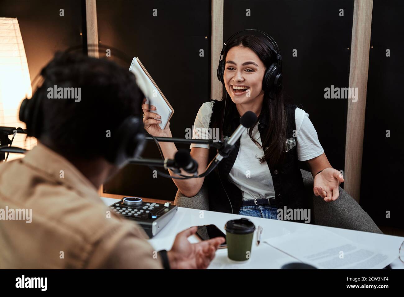 Two woman laughing sitting portait hi-res stock photography and images ...