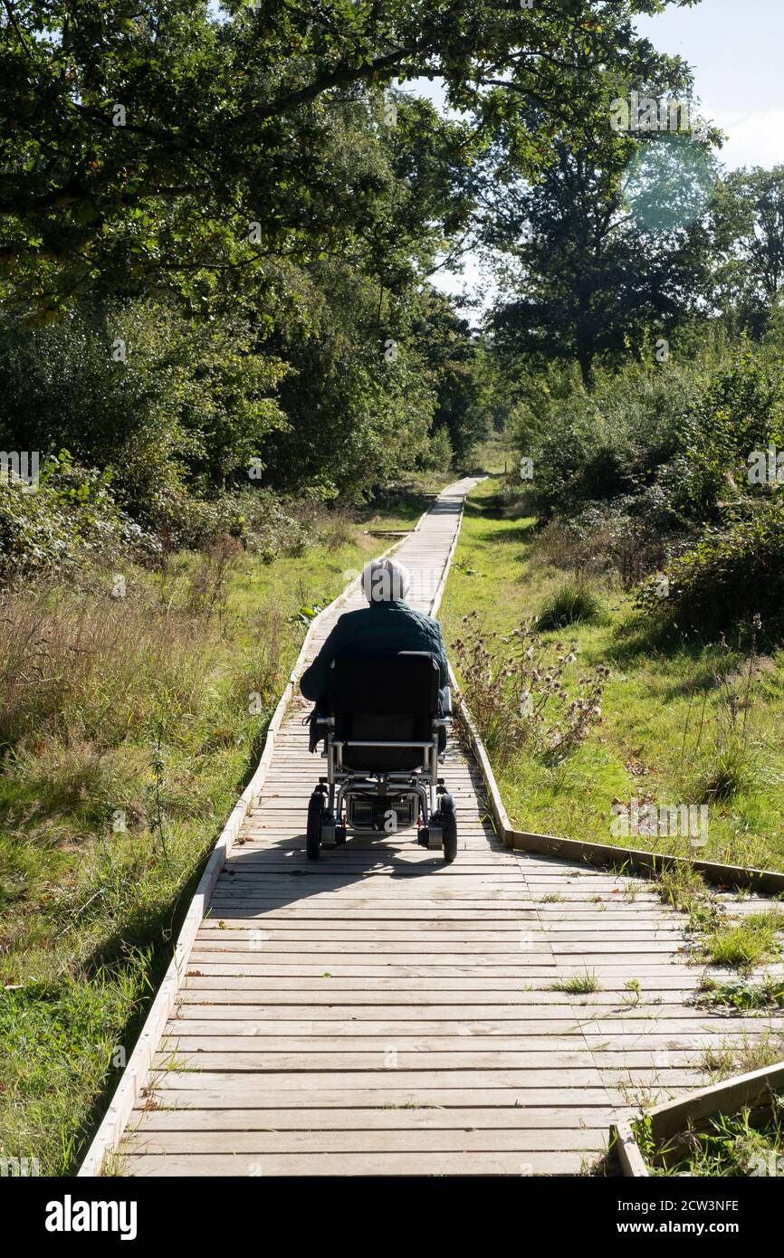 A lady using an electric wheelchair on specially built accessible ...