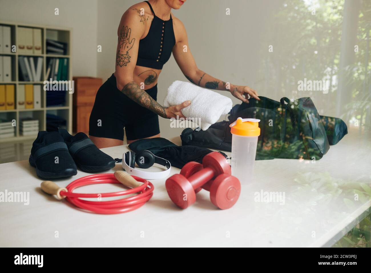 Sportswoman packing gym bag Stock Photo - Alamy