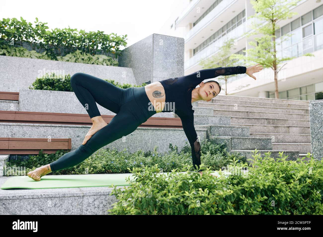 Woman doing variation of wild thing pose Stock Photo - Alamy
