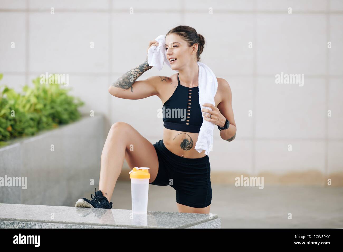 Sportswoman wiping off sweat Stock Photo - Alamy