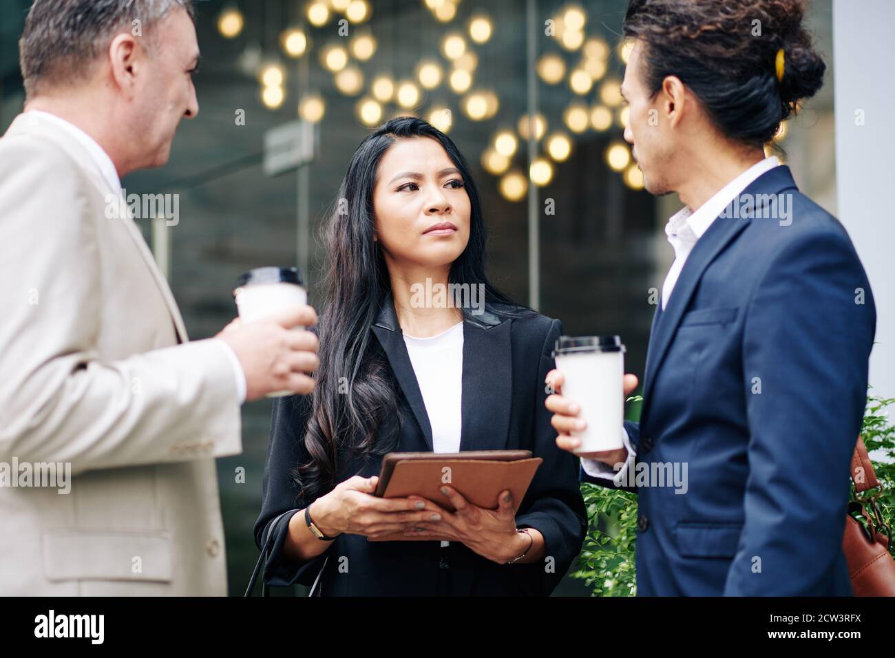 Business people talking outdoors Stock Photo - Alamy