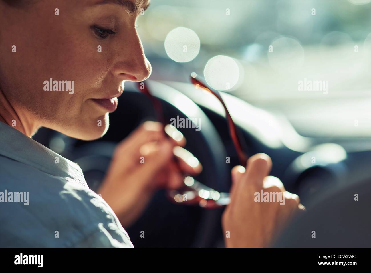 Close up portrait of tired middle aged business woman taking off ...