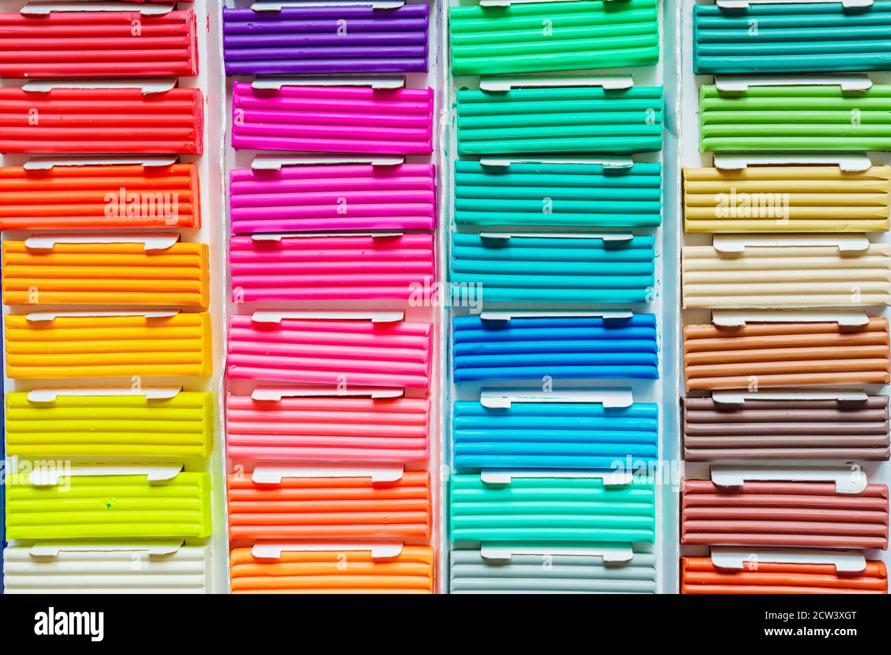 Rainbow colors of modeling clay. Multicolored plasticine bars ina box ...