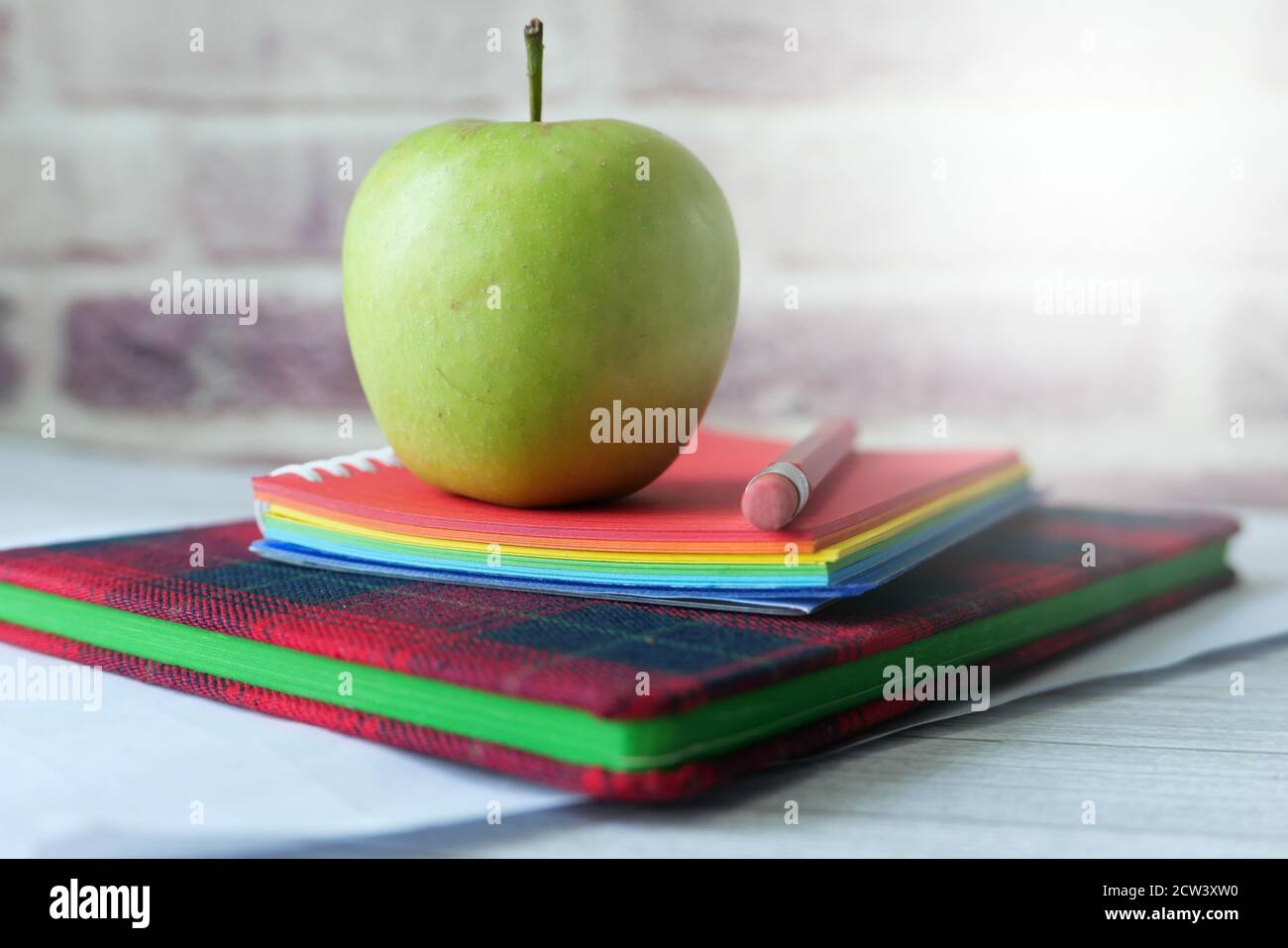 black to school concept with apple on notepad on table Stock Photo - Alamy