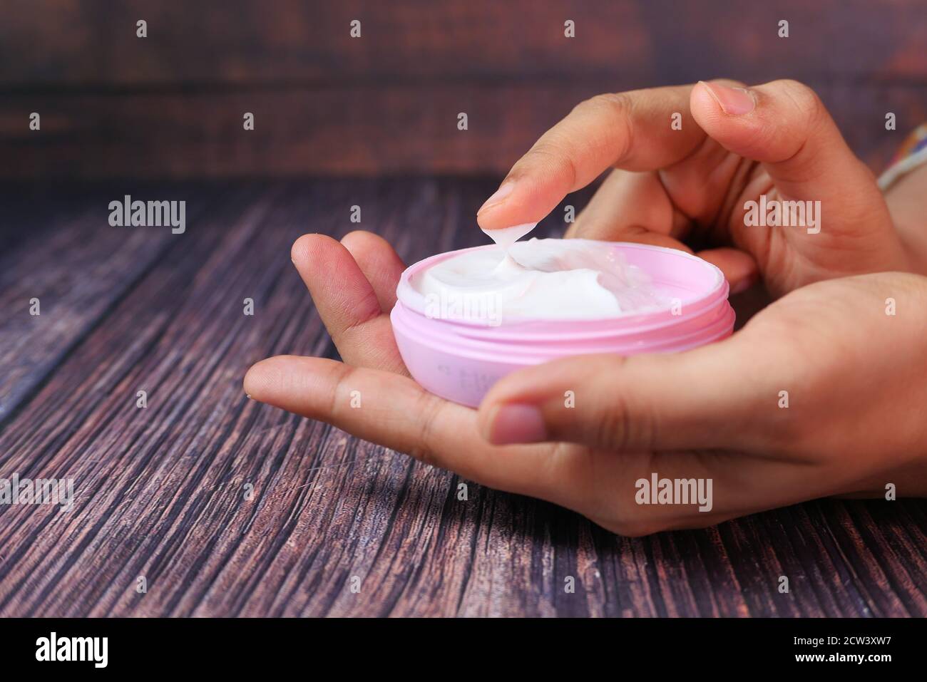 woman applying beauty cream onto skin at home top view Stock Photo - Alamy