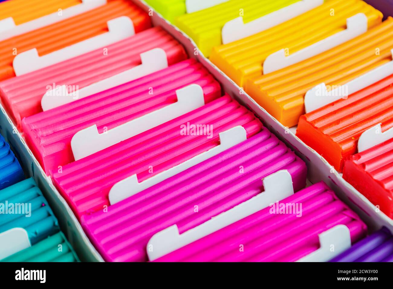 Rainbow colors of modeling clay. Multicolored plasticine bars ina box ...
