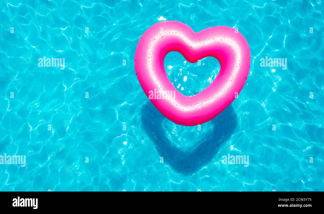 Inflatable rose heart buoy swim in the swimming pool view from above ...