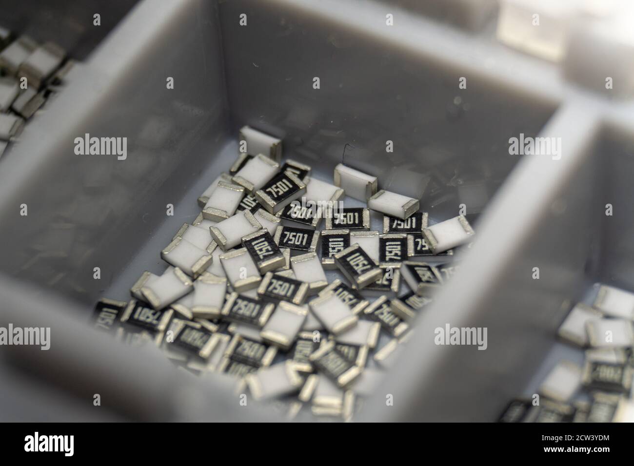 Grey scattered microscopic SMT surface mount chip resistors sorted in ...