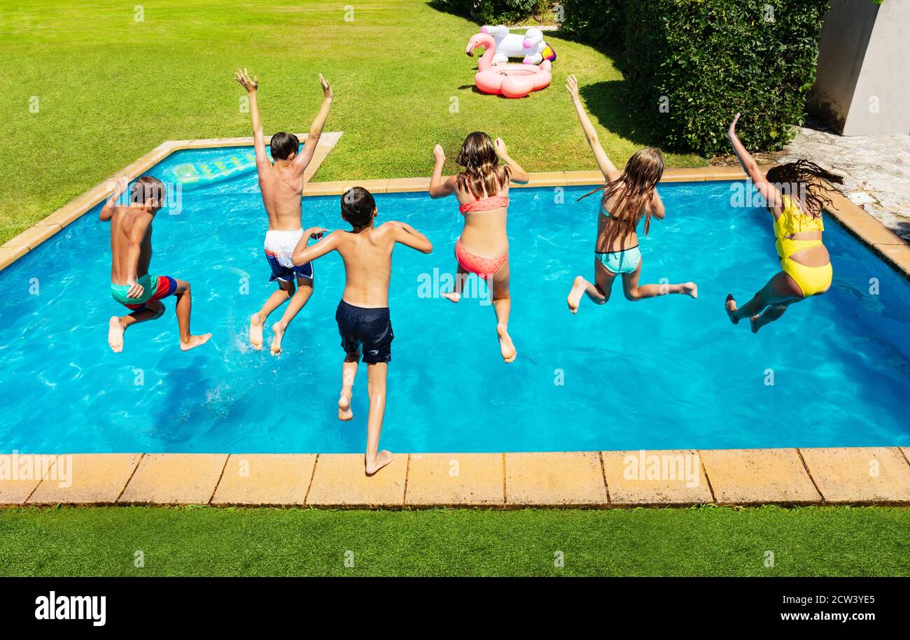 Many cute children jump into the swimming pool about to dive view from ...
