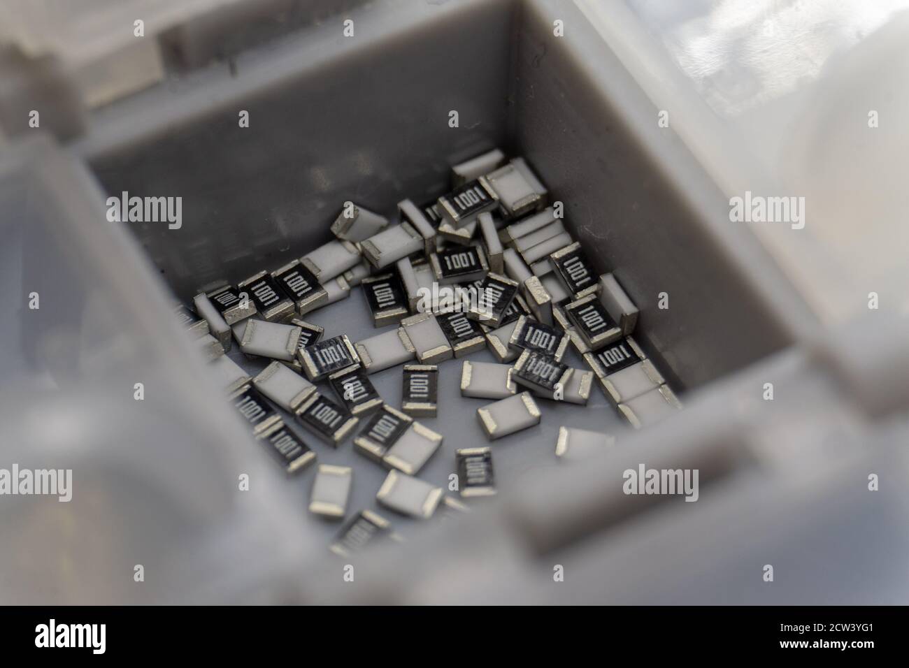 Grey scattered microscopic SMT surface mount chip resistors sorted in ...