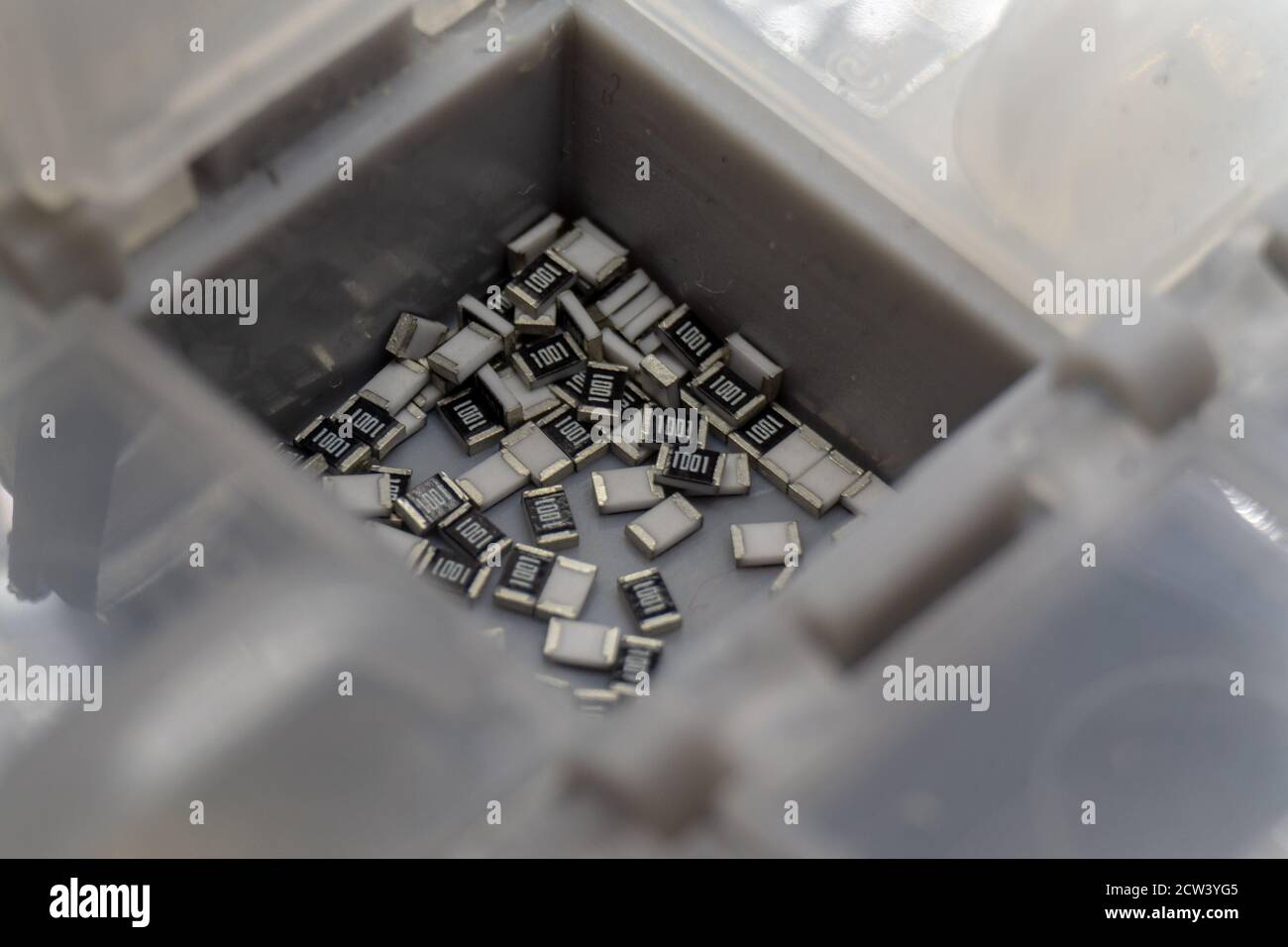 Grey scattered microscopic SMT surface mount chip resistors sorted in ...