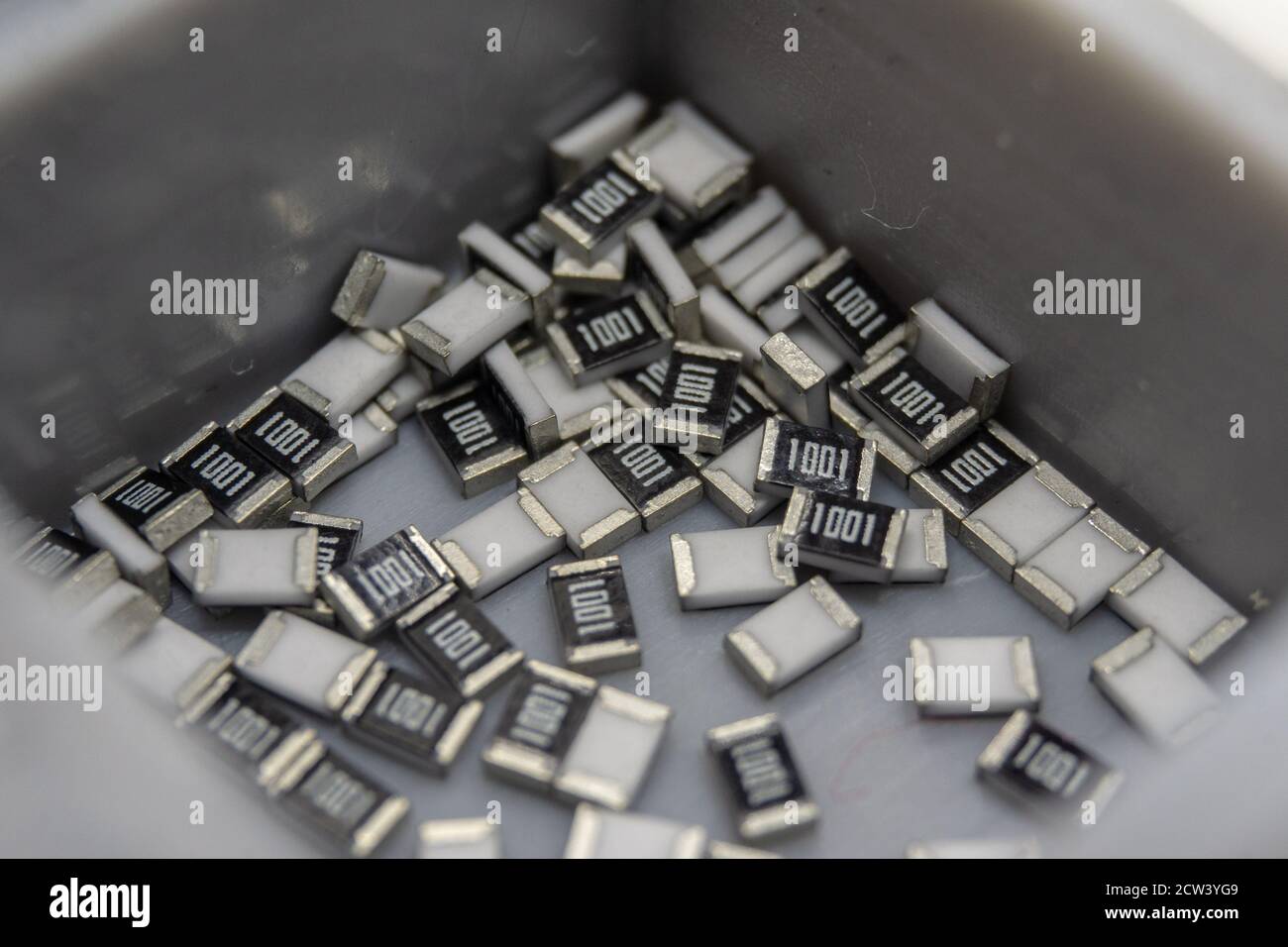 Grey scattered microscopic SMT surface mount chip resistors sorted in ...