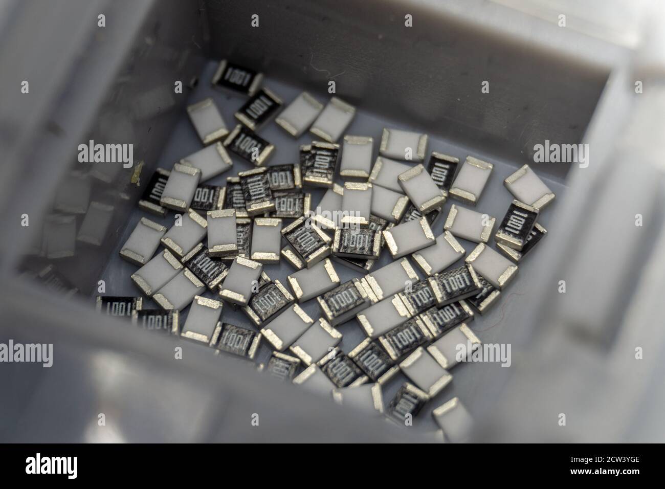 Grey scattered microscopic SMT surface mount chip resistors sorted in ...