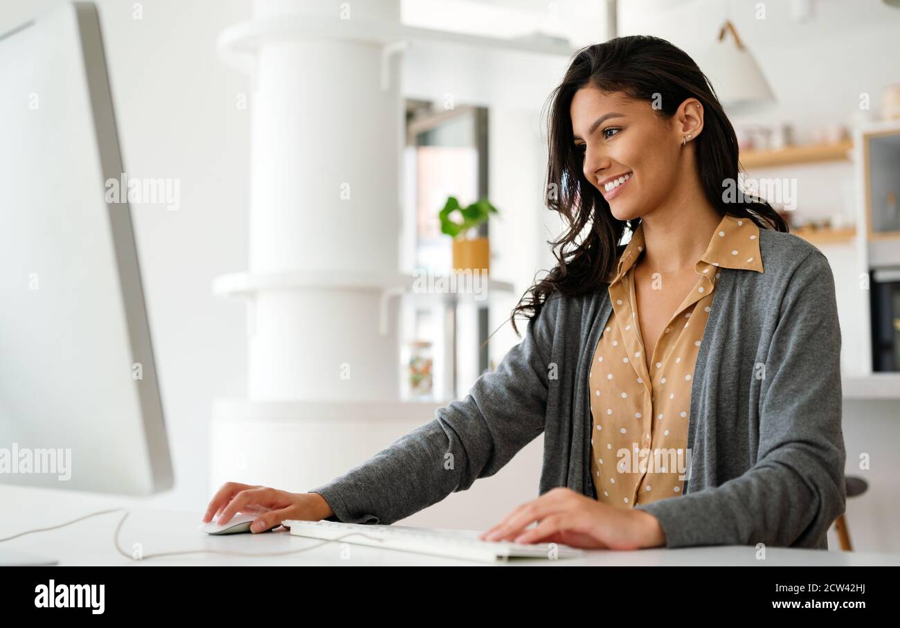 Beautiful student woman learning online on computer at home. Technology ...