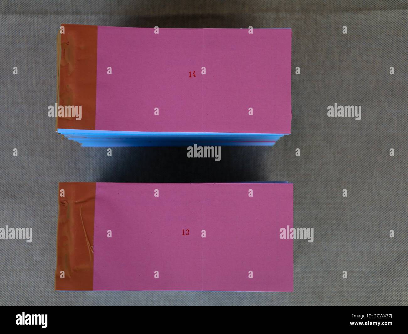 Light rose color bill books or receipt books on a cream color ...