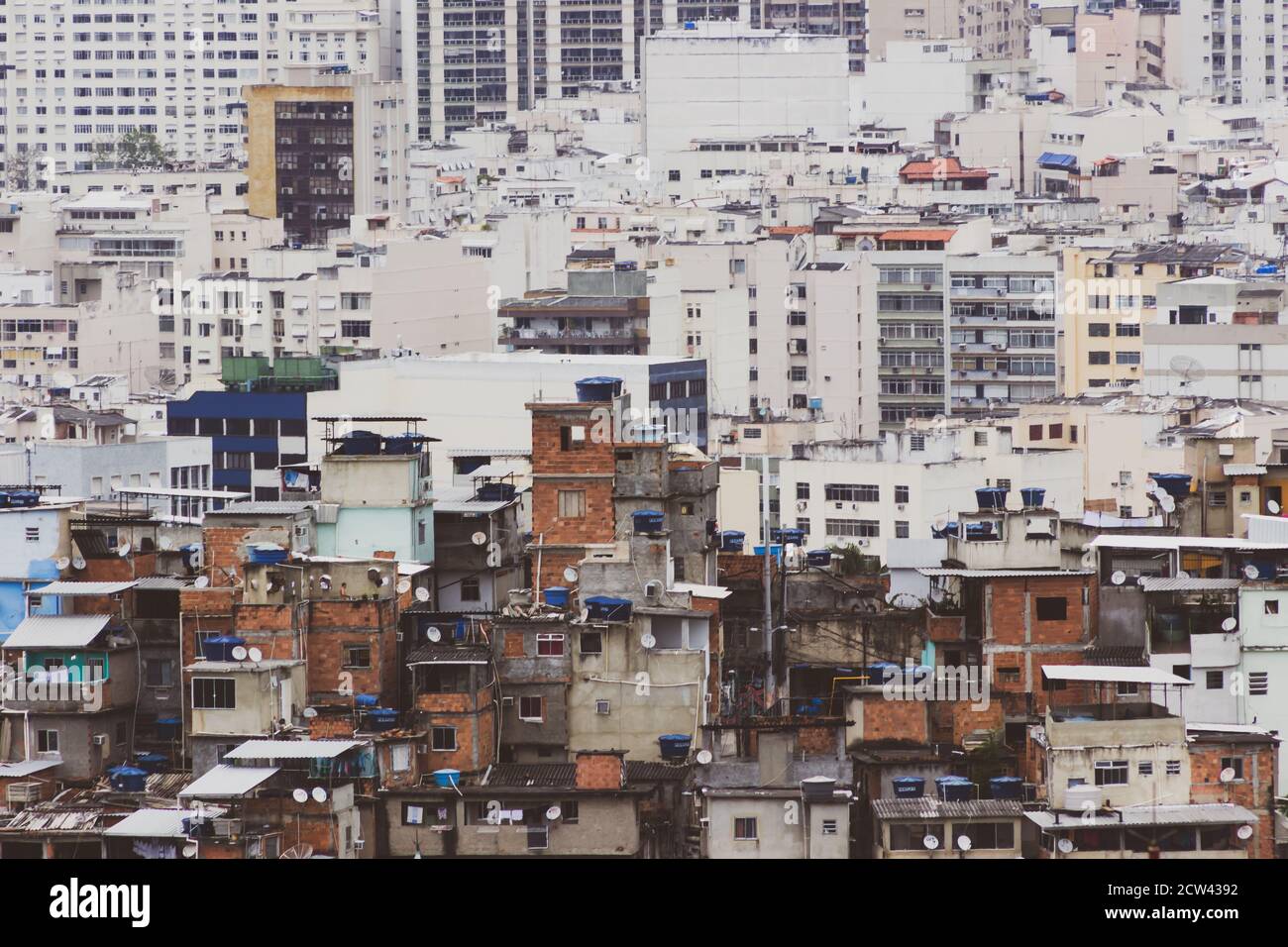 Brazilian social contrast. Favela and buildings. Cloudy weather. Rio de ...