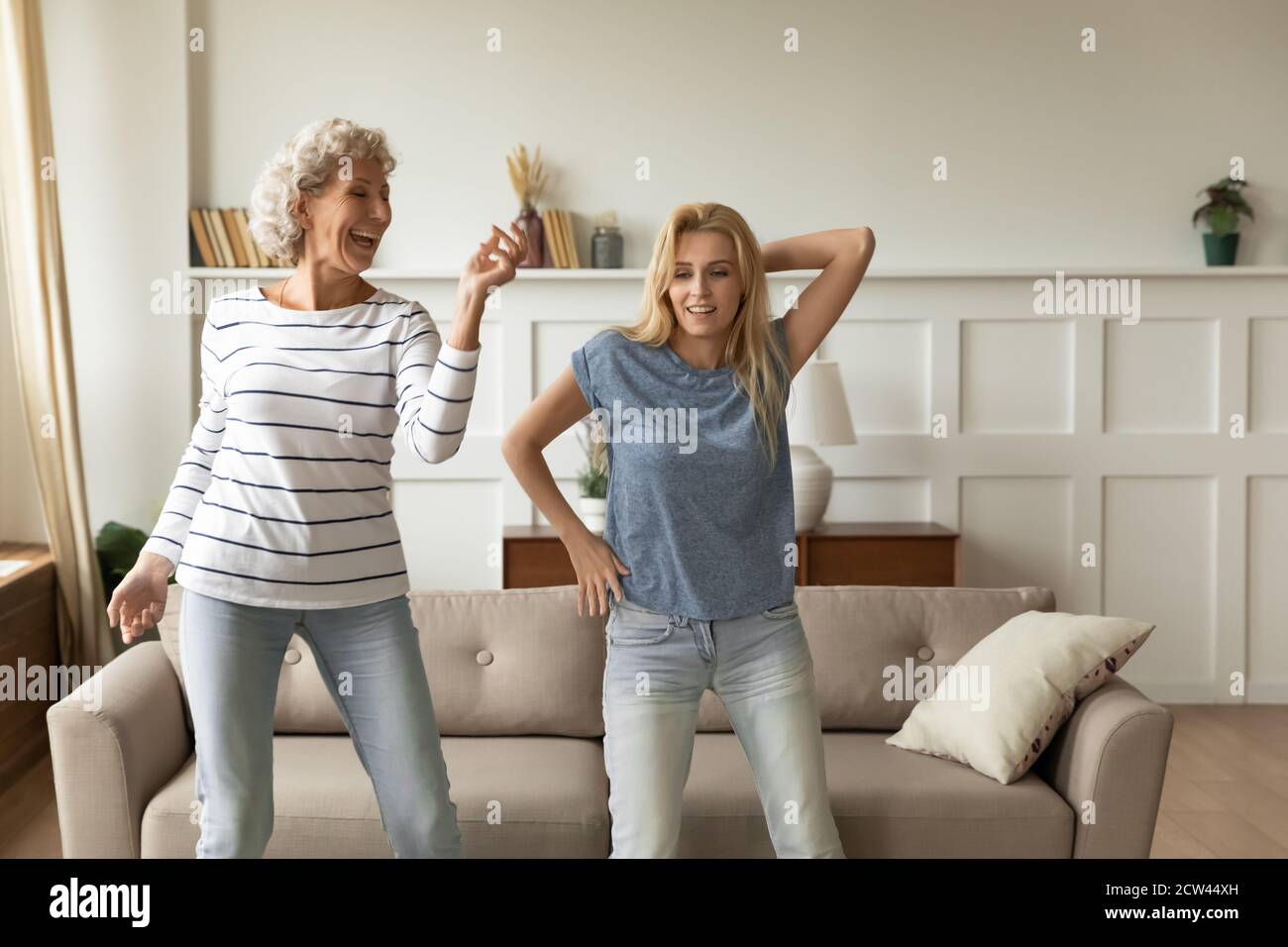 Younger and elder women of different generations dancing having fun ...