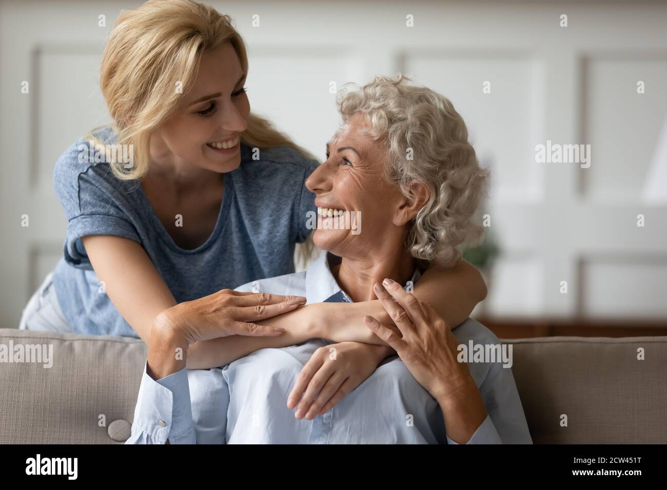 Two best friends women of different generations hugging close together ...