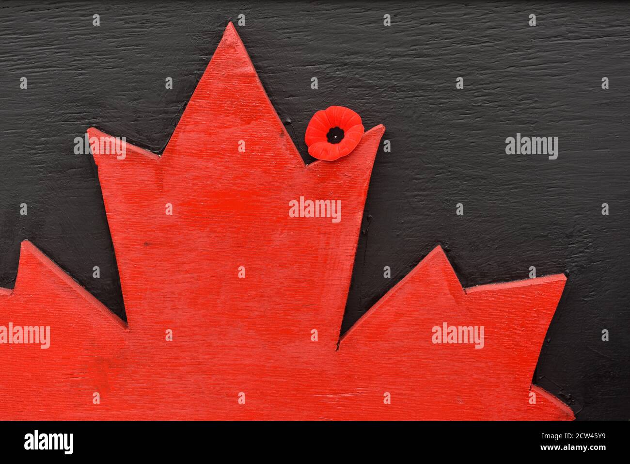 Wooden Canada leaf and poppy. Remembrance Day. Poppy day. Canada Day ...