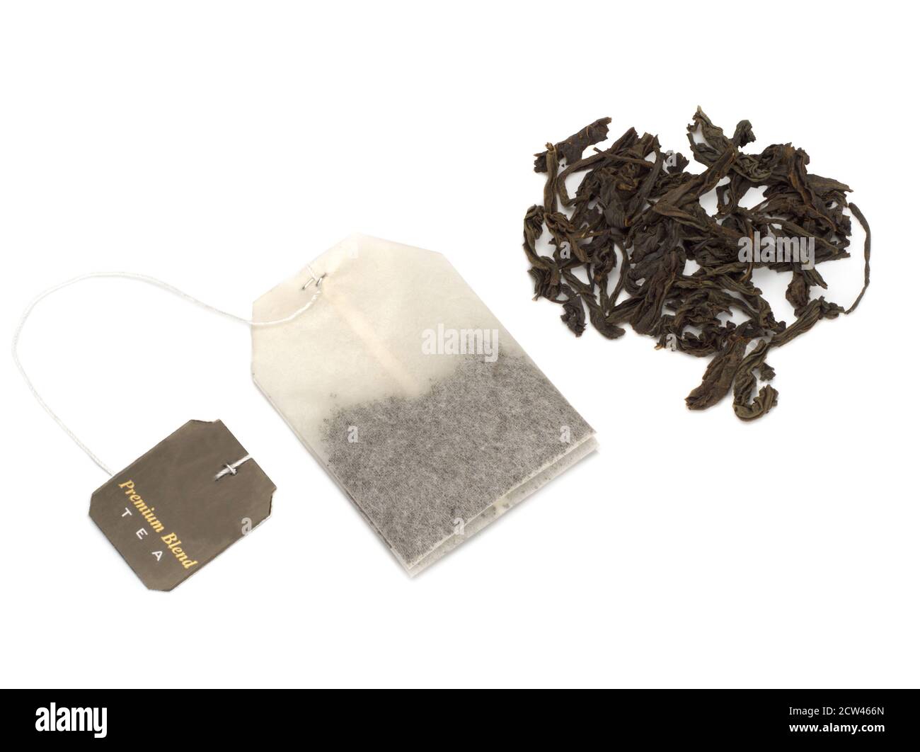Black tea bag and black tea heap on white background Stock Photo - Alamy