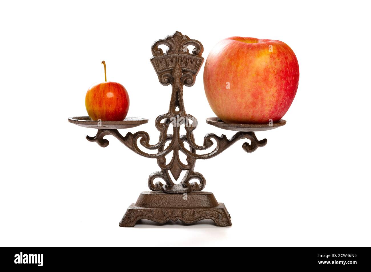 a small apple and a giant size apple on a balanced scale Stock Photo ...